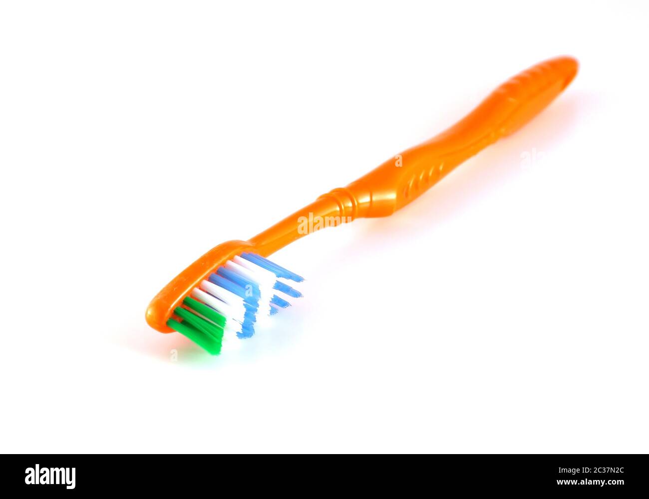 Orange toothbrush over white Stock Photo - Alamy