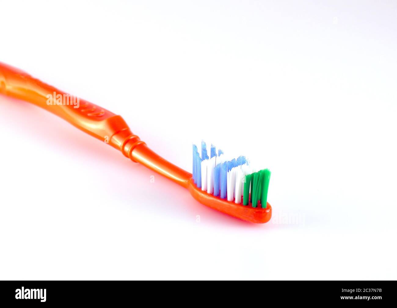 Orange toothbrush over white Stock Photo - Alamy
