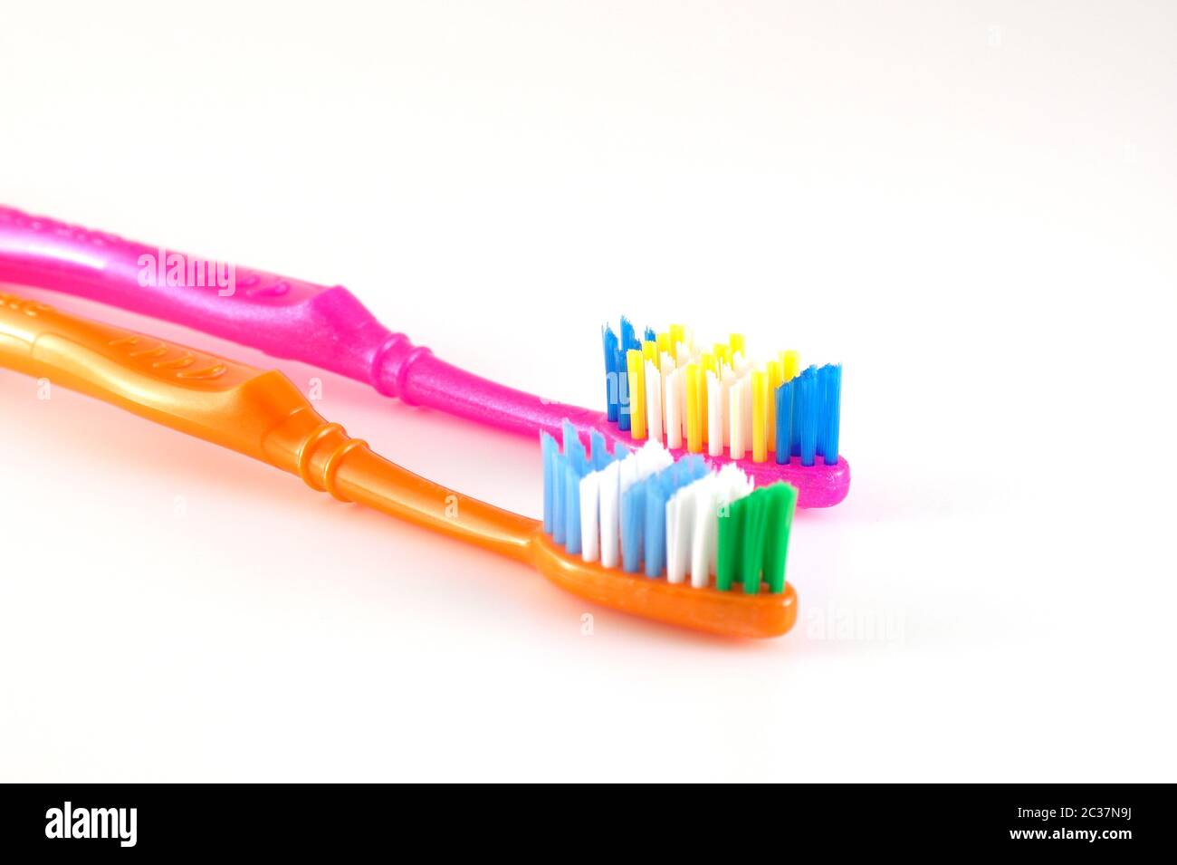 Two tooth-brushes over white Stock Photo - Alamy