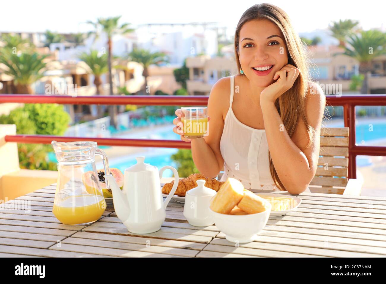 Breakfast woman eating brunch on travel in resort hotel drinking fresh ...