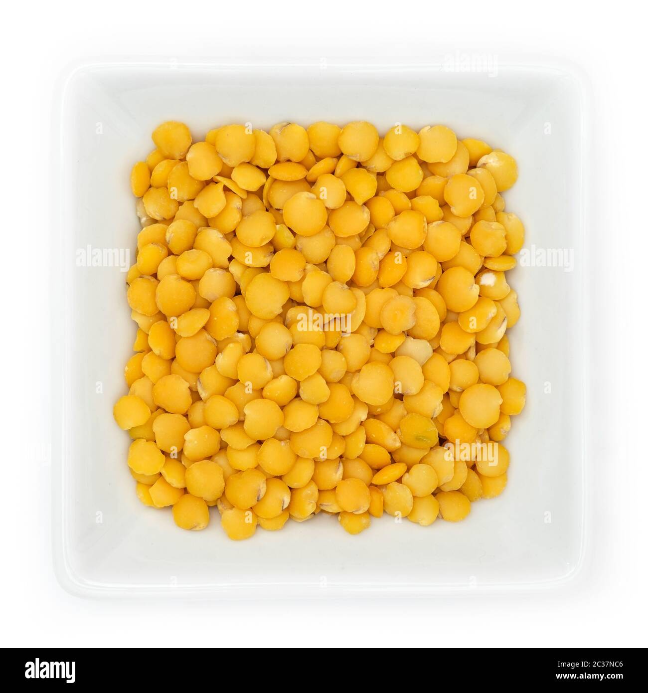 Yellow lentils in a white square bowl in top view Stock Photo - Alamy