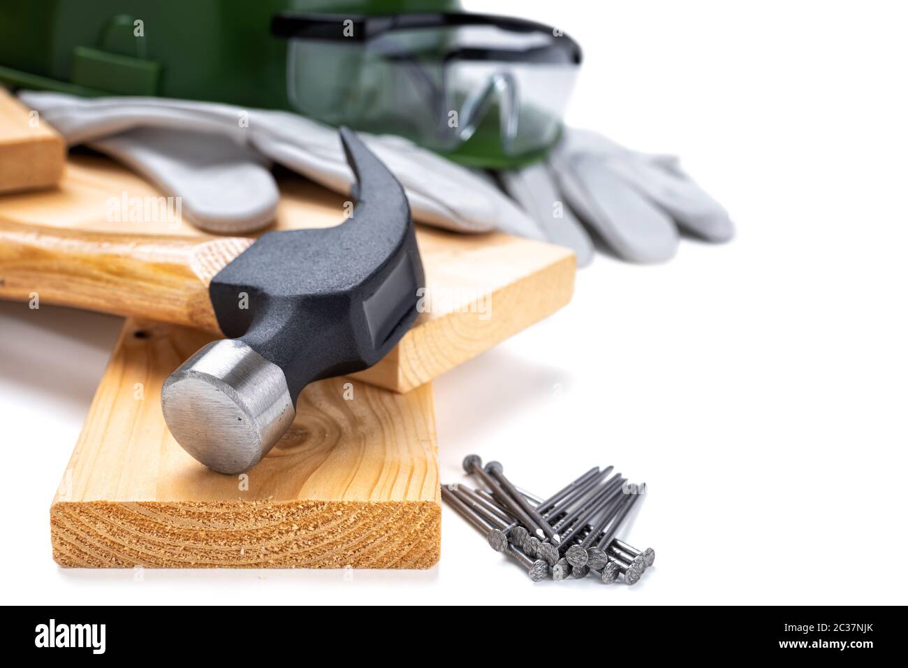 Close-up of a carpenter's hammer, helmet and leather protective gloves ...