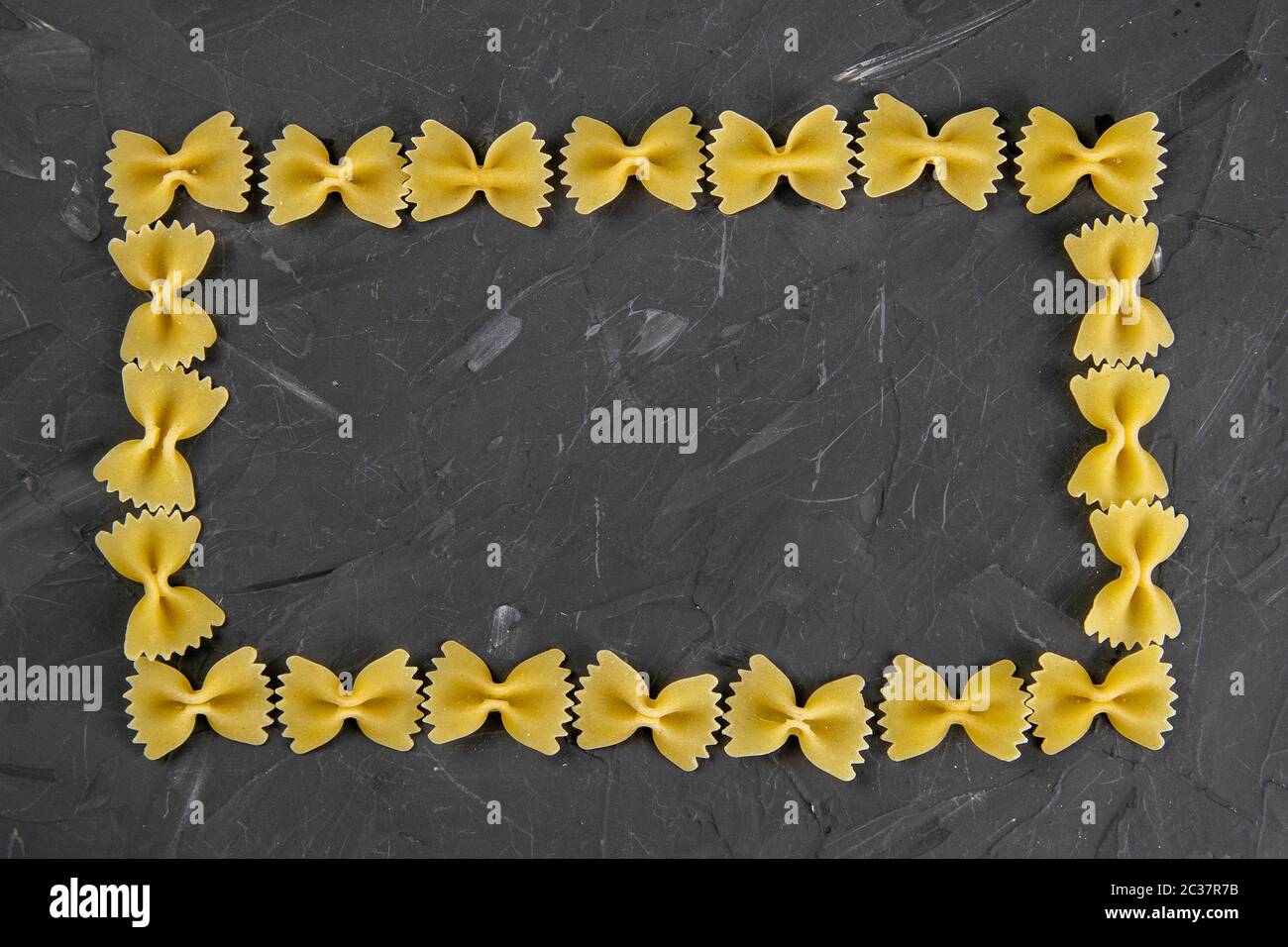 Farfalle Raw farfallini colored italian pasta on a wood black ...