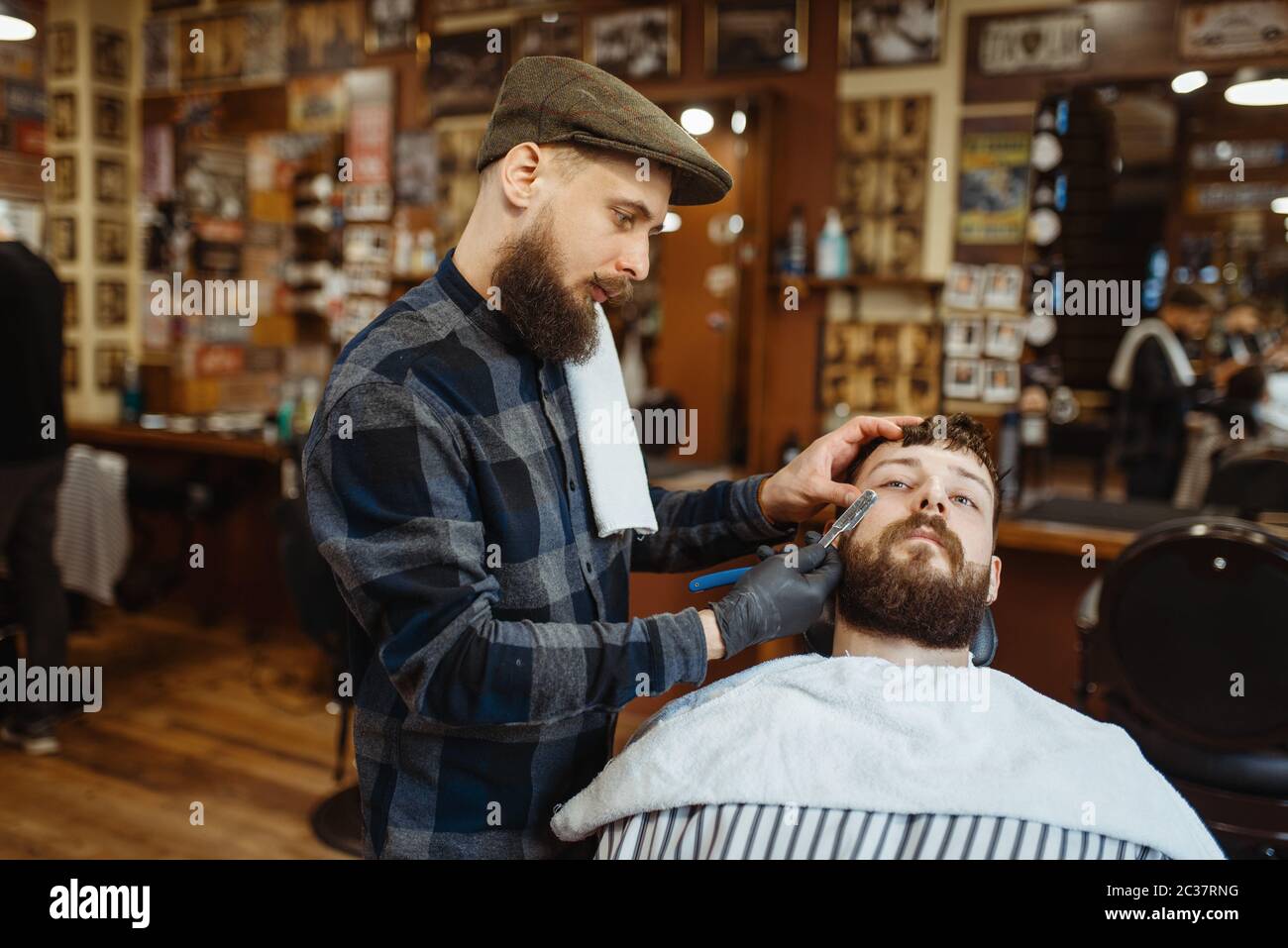 Barber with razor, old school beard cutting. Professional barbershop is ...