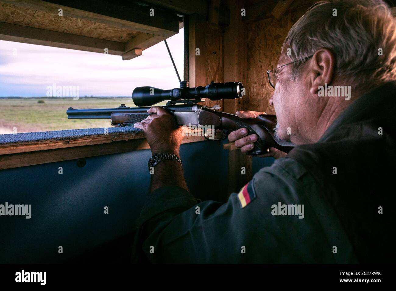 Hunter on a high seat Stock Photo - Alamy