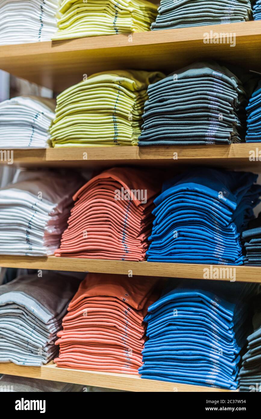 Clothing products on the shelf in a clothing store Stock Photo - Alamy