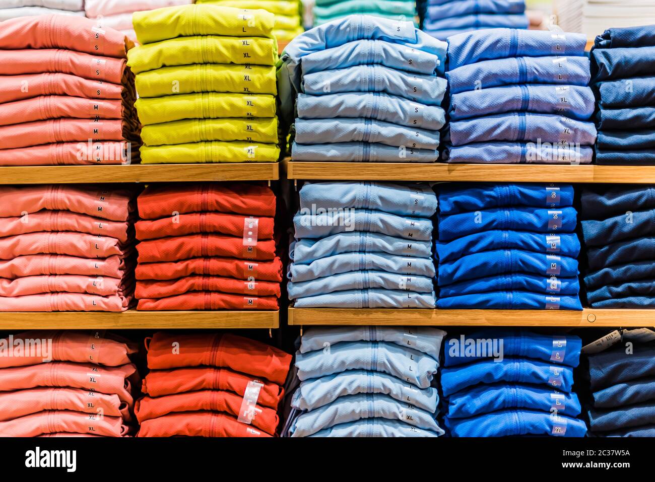 Clothing products on the shelf in a clothing store Stock Photo - Alamy