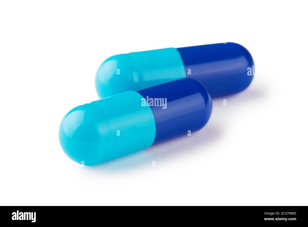 Blue capsules with powder isolated on white background Stock Photo - Alamy