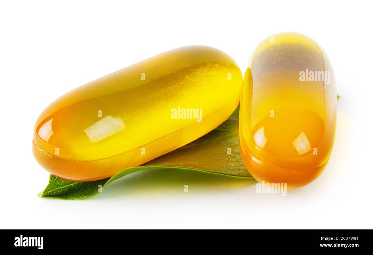 Medicinal capsule with a leaf isolated on white background Stock Photo ...