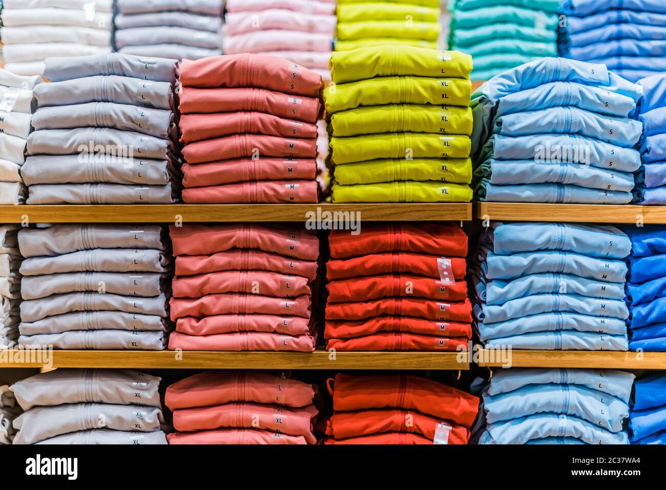 Clothing products on the shelf in a clothing store Stock Photo - Alamy
