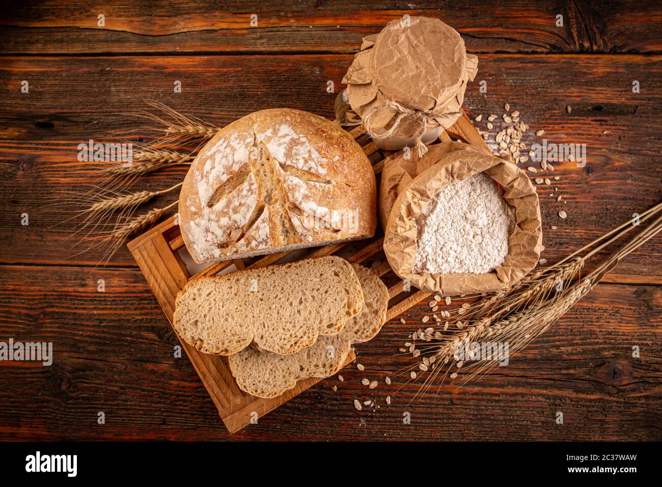 Flat lay of a rustic loaf of bread on an old wooden table Stock Photo ...