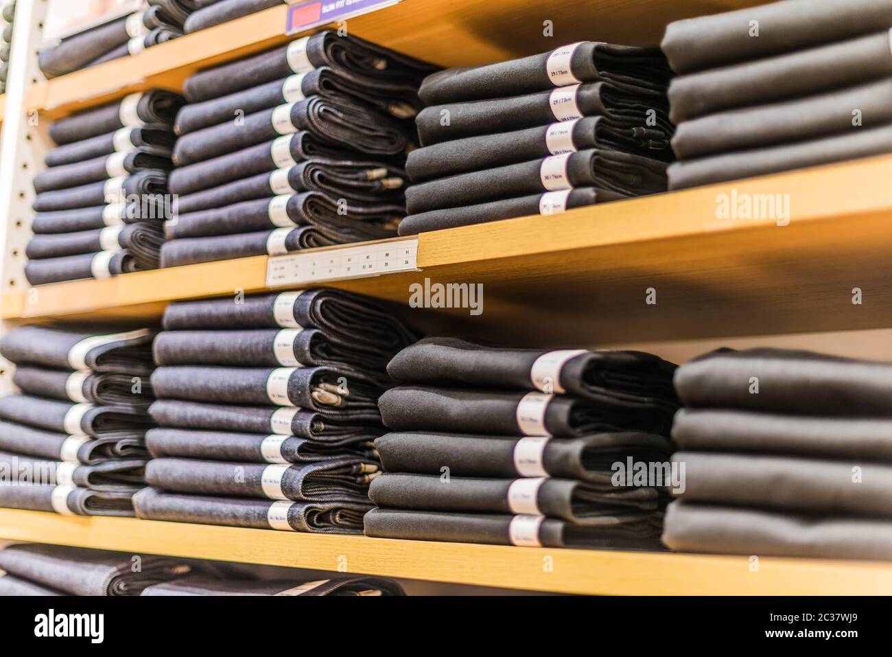 Clothing products on the shelf in a clothing store Stock Photo - Alamy