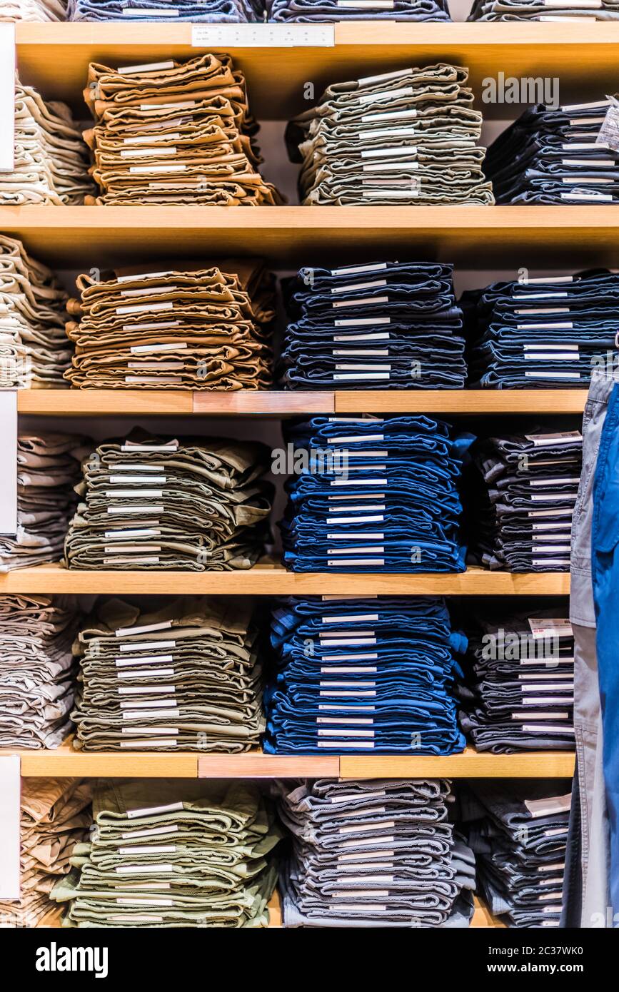 Clothing products on the shelf in a clothing store Stock Photo - Alamy