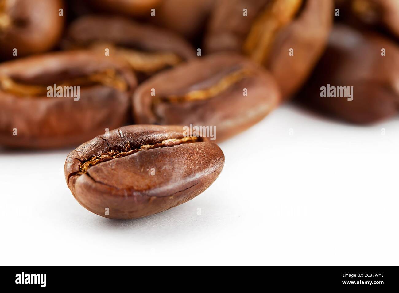 Roasted shiny grains of coffee isolated on white background Stock Photo ...