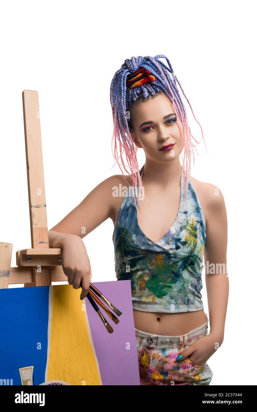 Confident young artist leaning on easel Stock Photo - Alamy