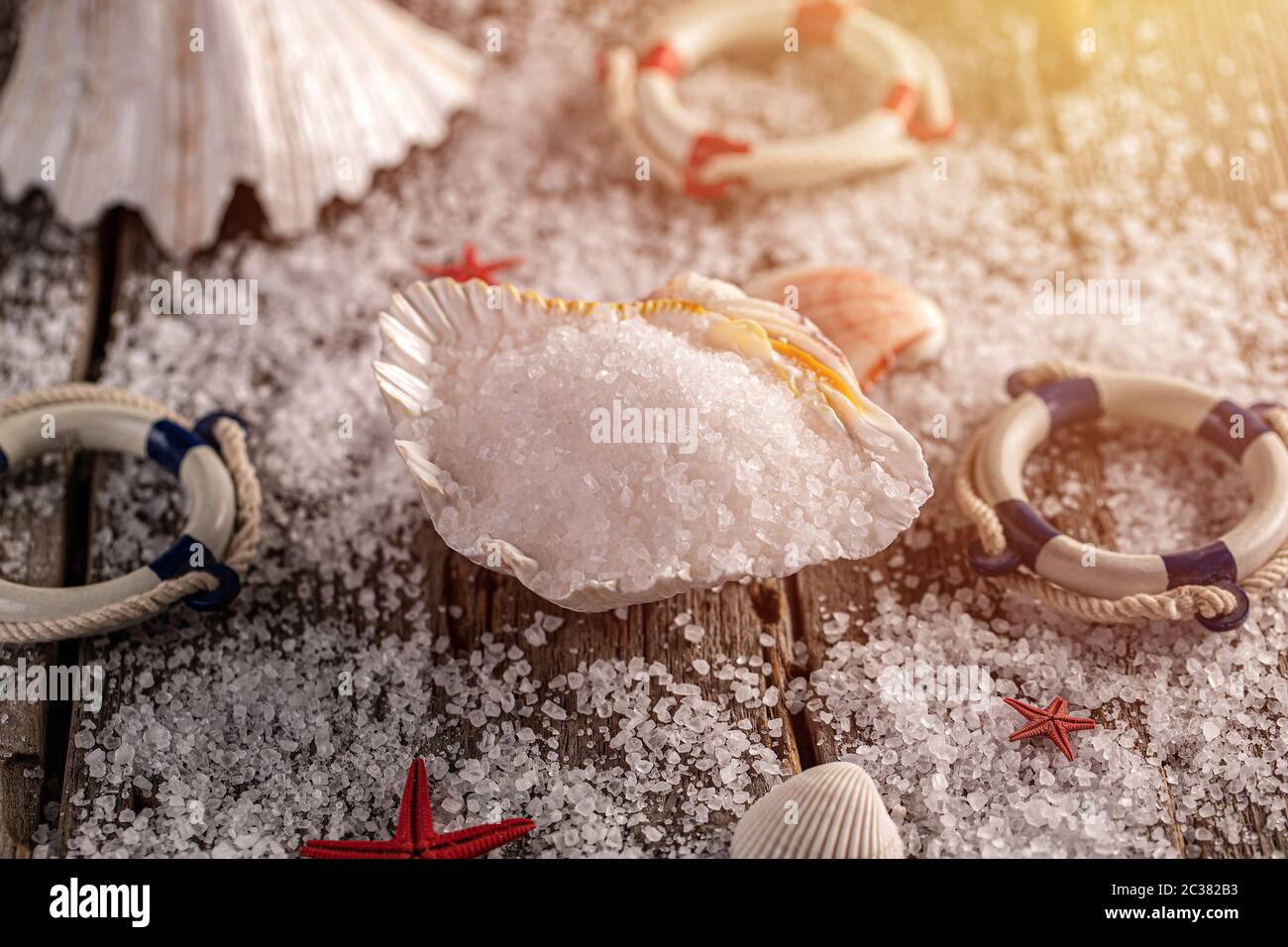 Luxurious sea salt flakes in seashell on wooden background Stock Photo - Alamy