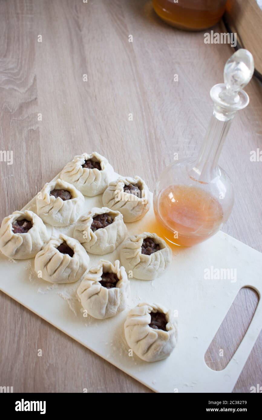 The process of making home-made dumplings. Raw homemade dumplings on a ...