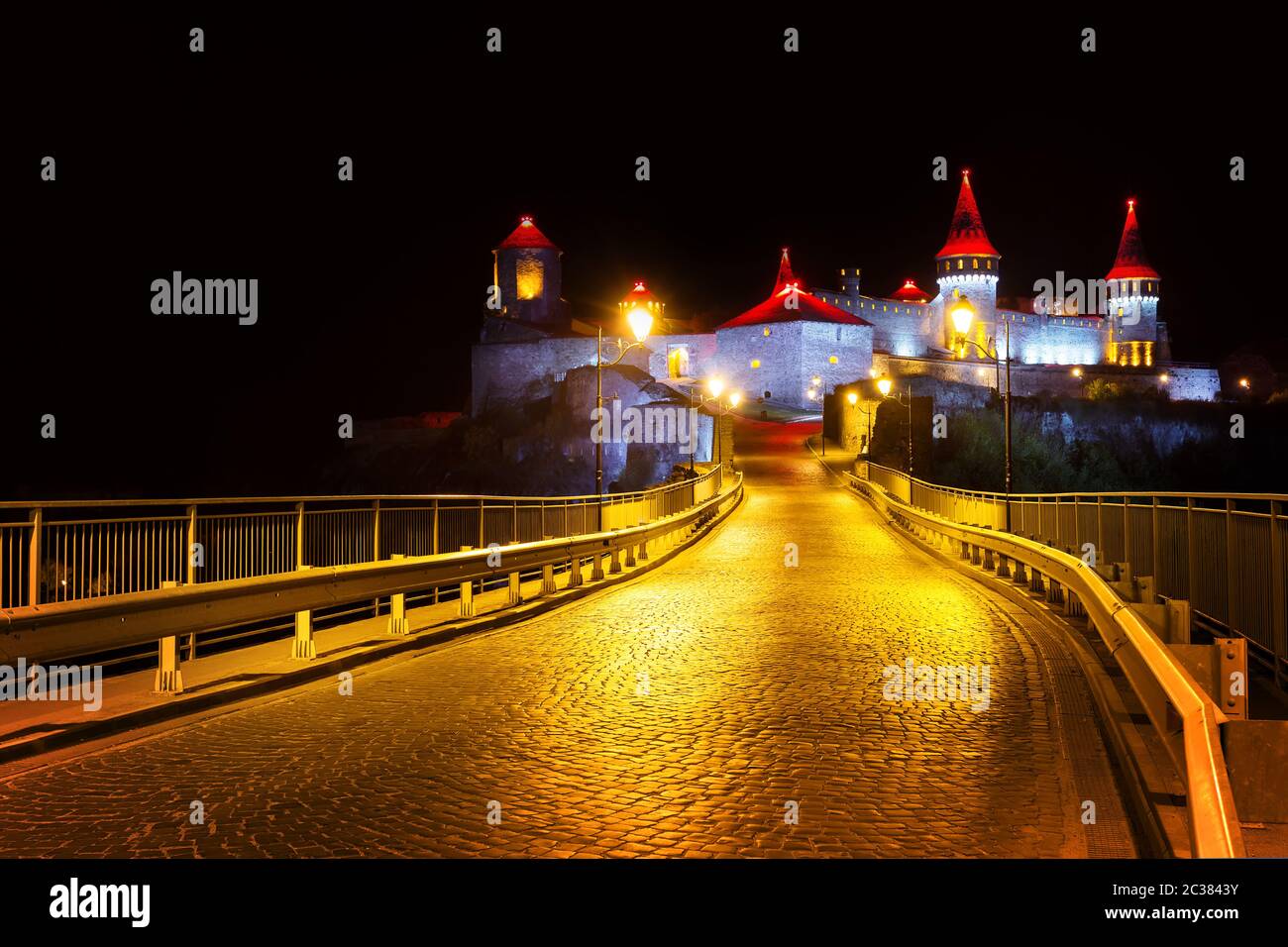 Cobbled bridge to the castle lit by golden light Stock Photo - Alamy