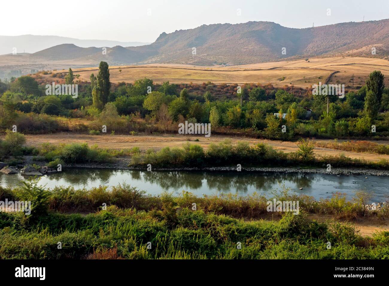 Landscape with the river Hrazdan and a mountain village in Armenia on ...