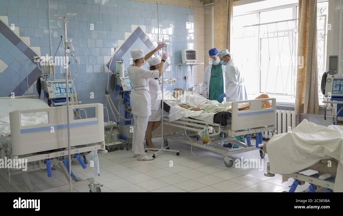 Group of doctors in resuscitation ward. Team of doctors examines ...