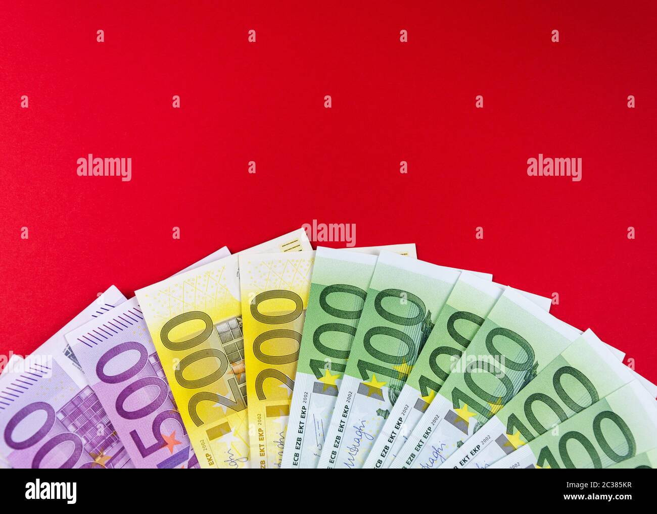 currency of the European Union of different denominations on an red ...