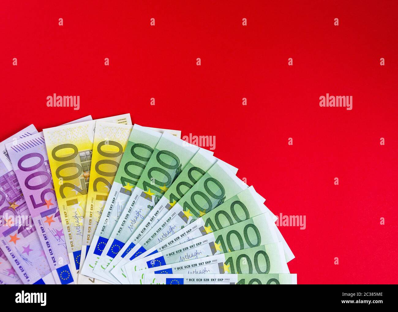currency of the European Union of different denominations on an red ...
