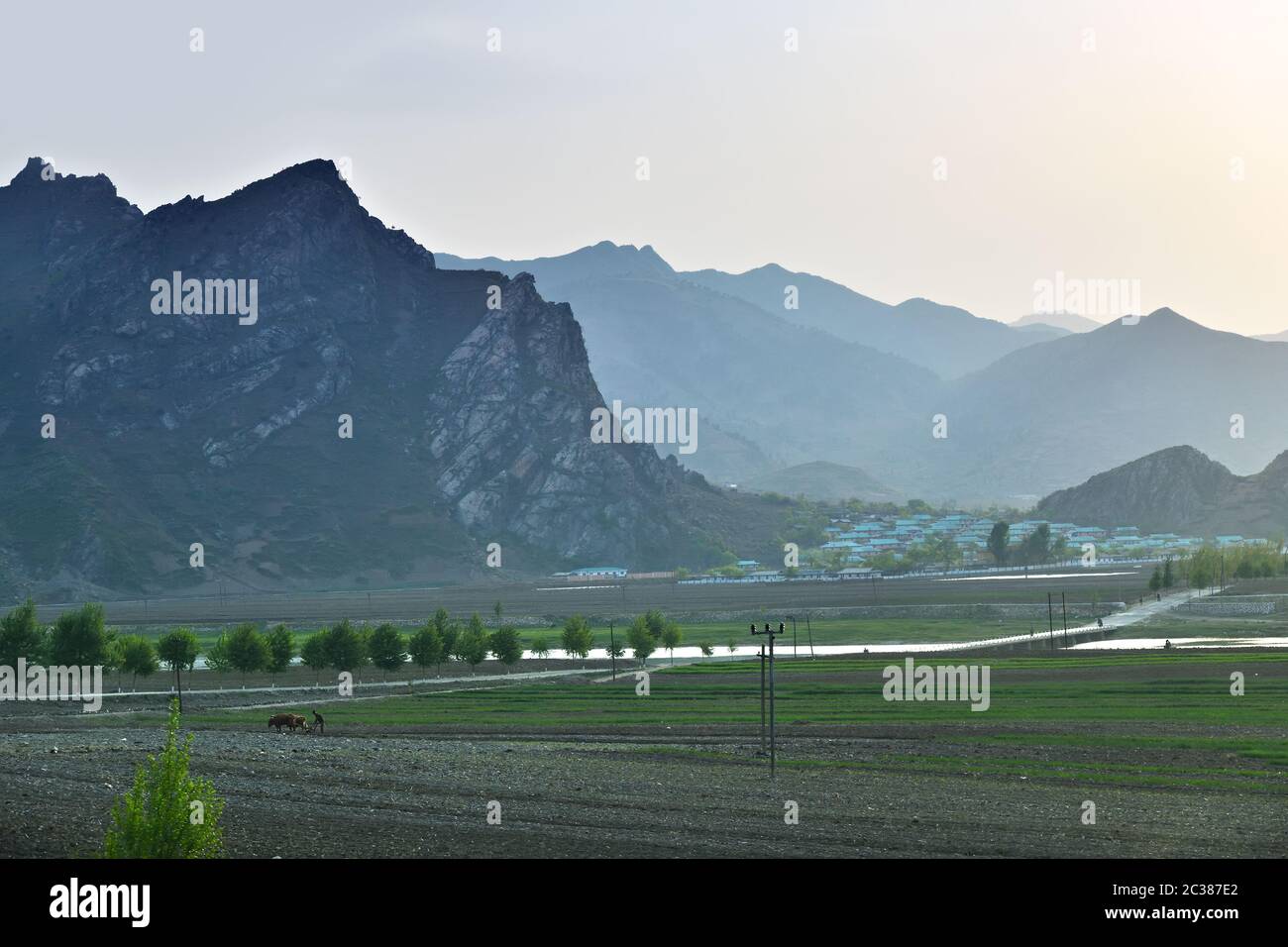 North Korea landscape. Mountains, village and plowed agriculture fields ...
