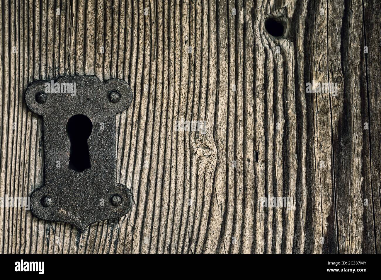 Iron keyhole on a wooden door Stock Photo - Alamy