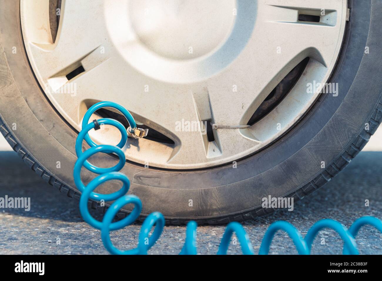 inflating the car tires with air using a compressor Stock Photo - Alamy