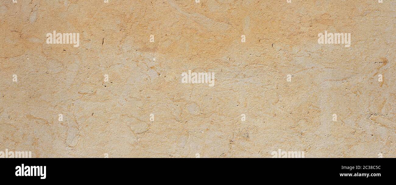 wide Yellow stone wall useful as a background Stock Photo - Alamy