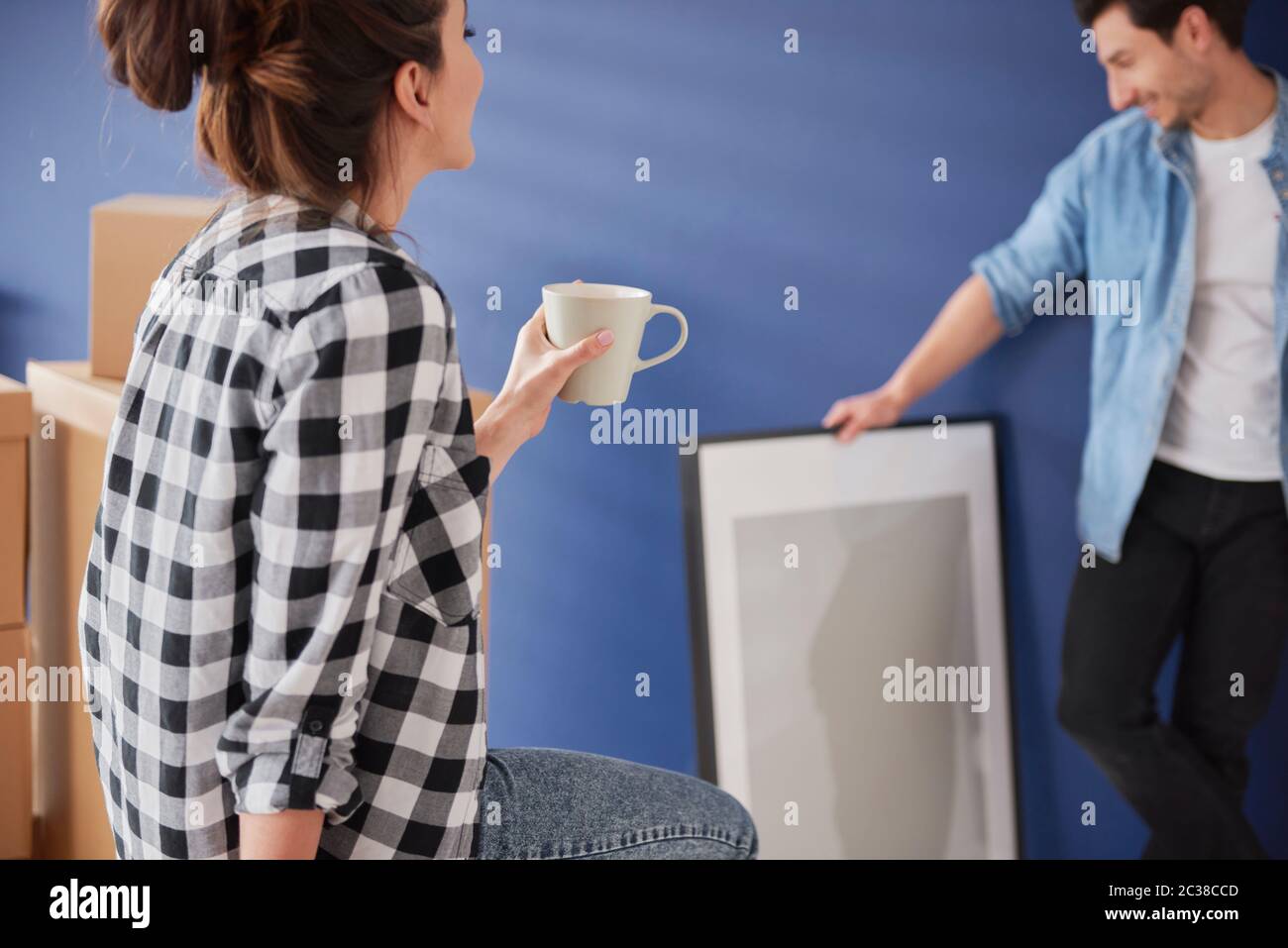 Couple having a break during moving a house Stock Photo - Alamy