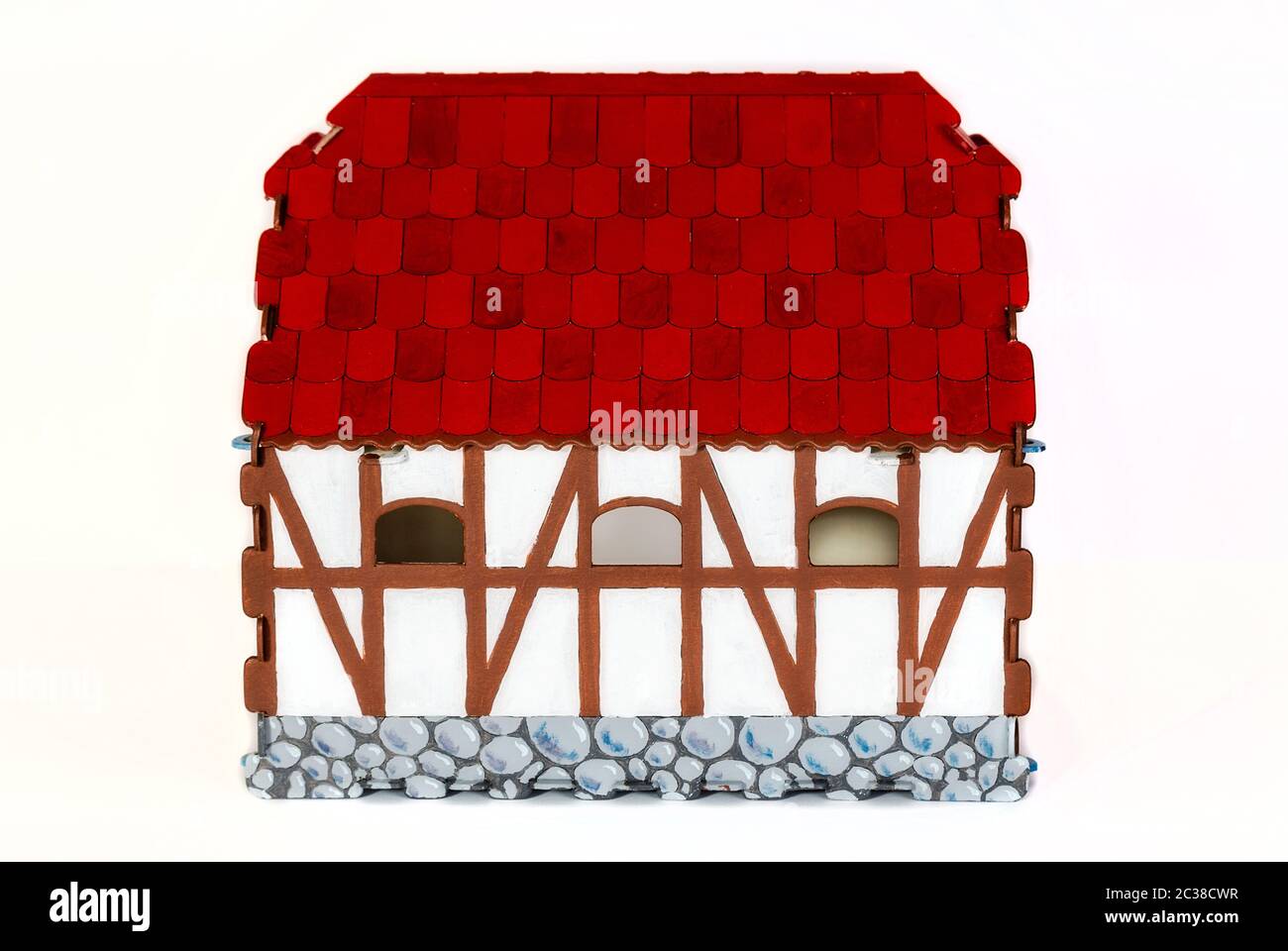 Toy house made of rural cardboard, front view, with a red roof on a ...