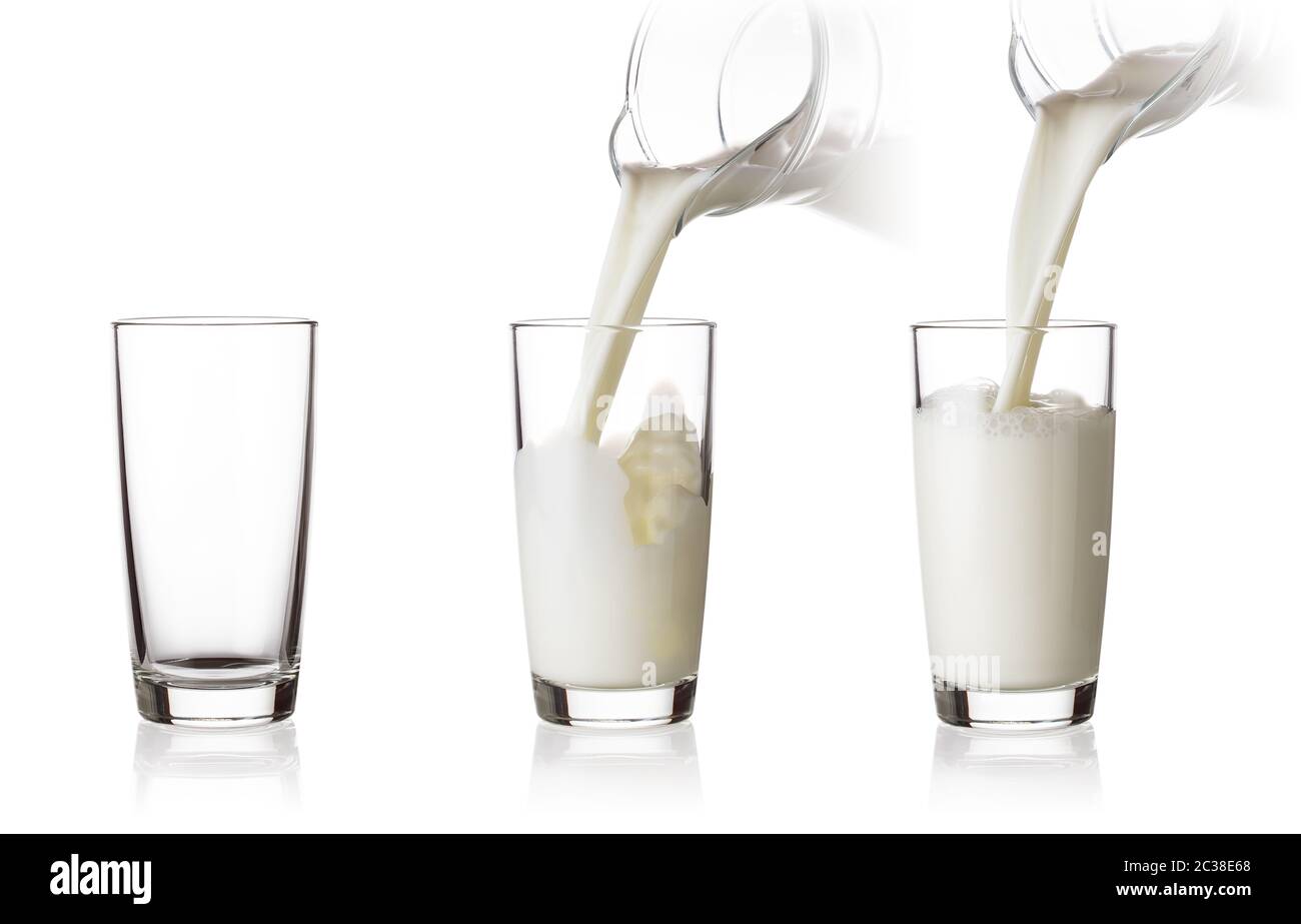 Process of filling a glass of milk from jug isolated on a white ...