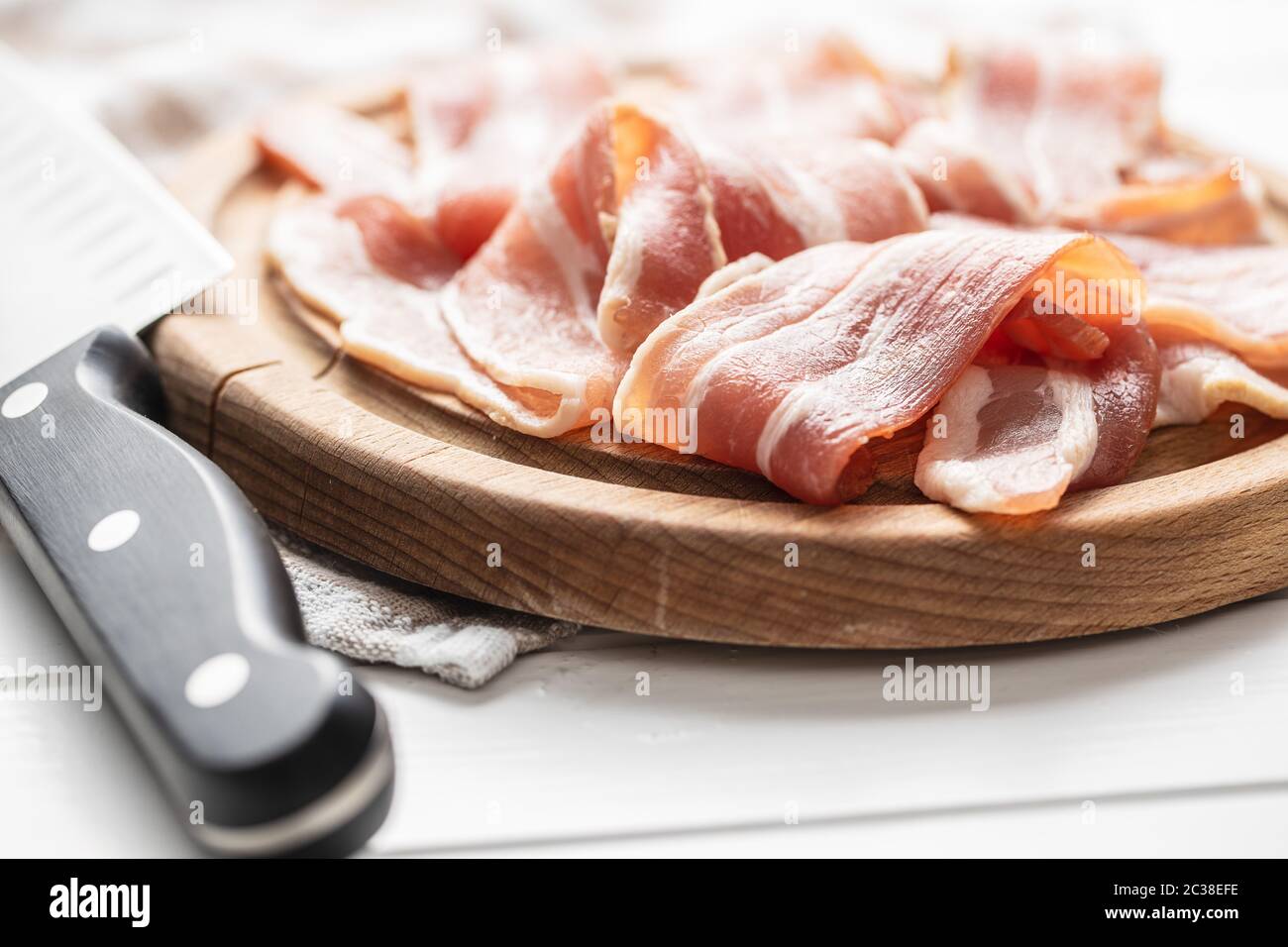 Smoked bacon strips on cutting board Stock Photo - Alamy