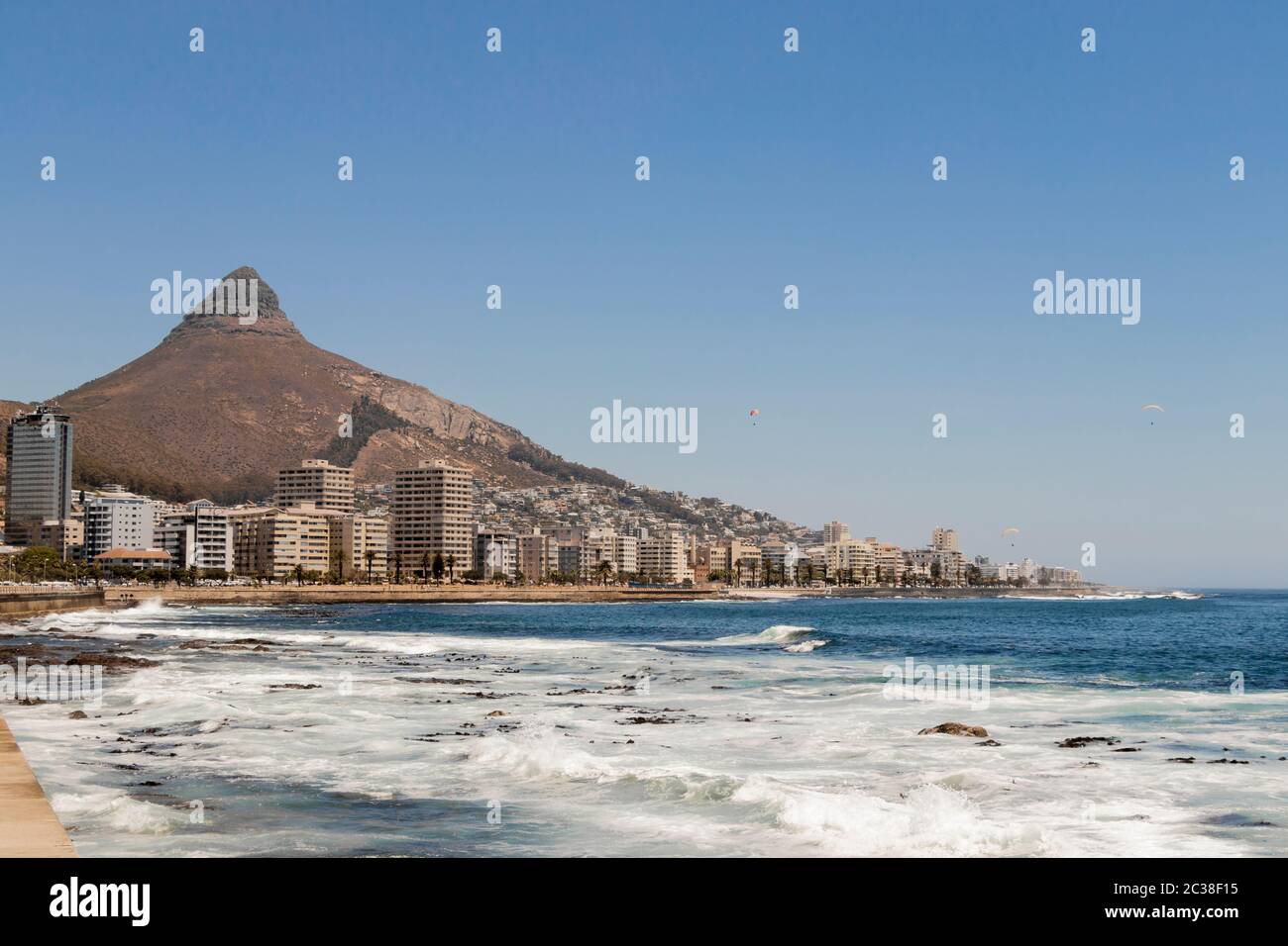 Mountains, hotels and deep blue water with waves at the Sea Point ...