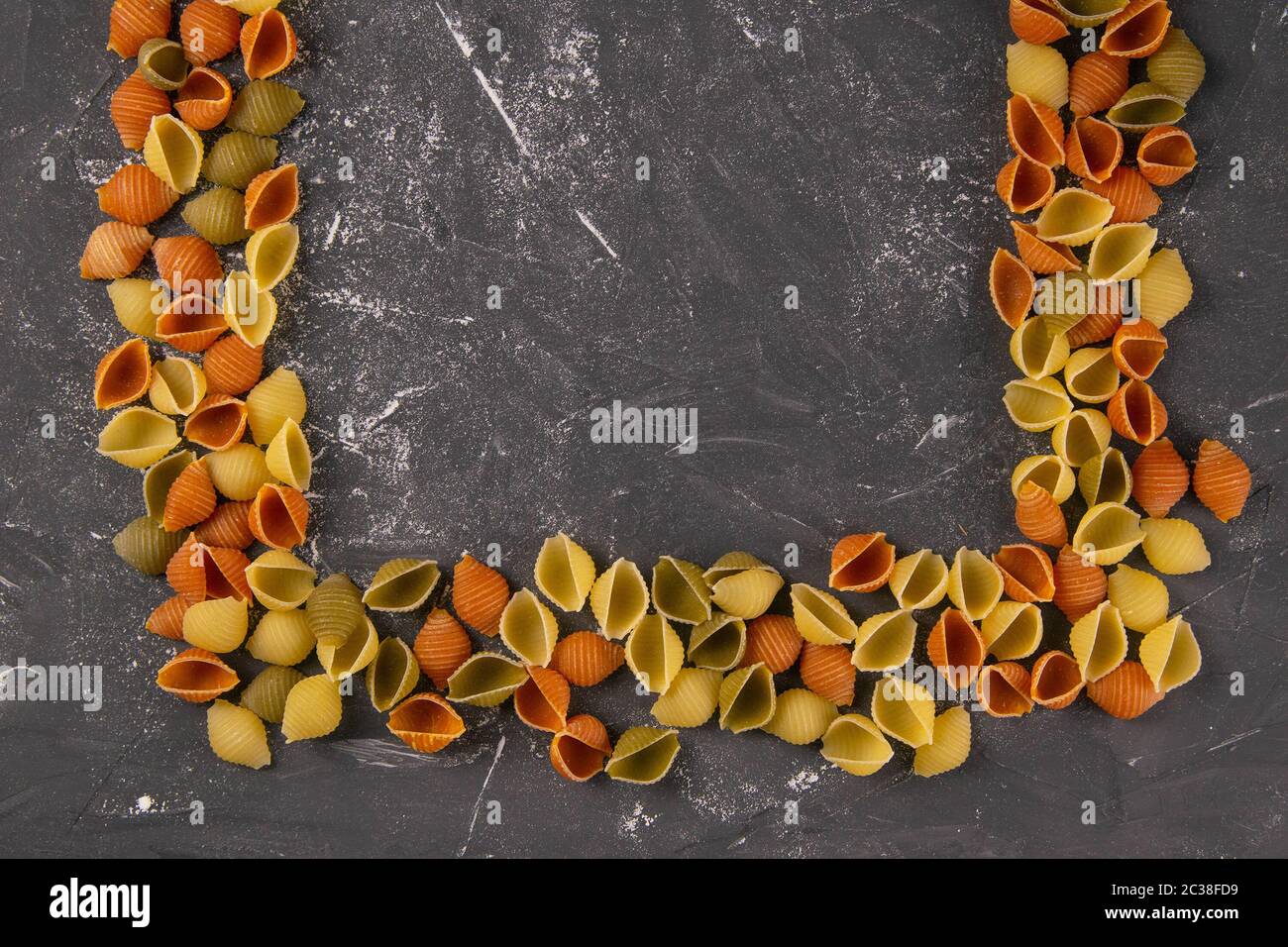 Pasta Conchiglie Rigate, mix of colorful uncooked shells in the shape ...