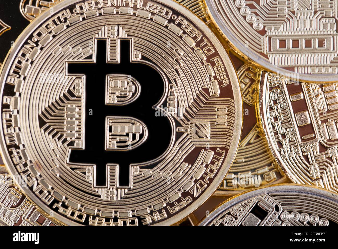 Bitcoin lying on the golden scattering of bitcoins isolated on white ...