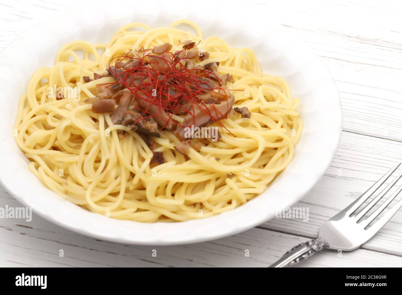 Pasta spaghetti with fresh shimeji mushroom, cream and cheese on table ...