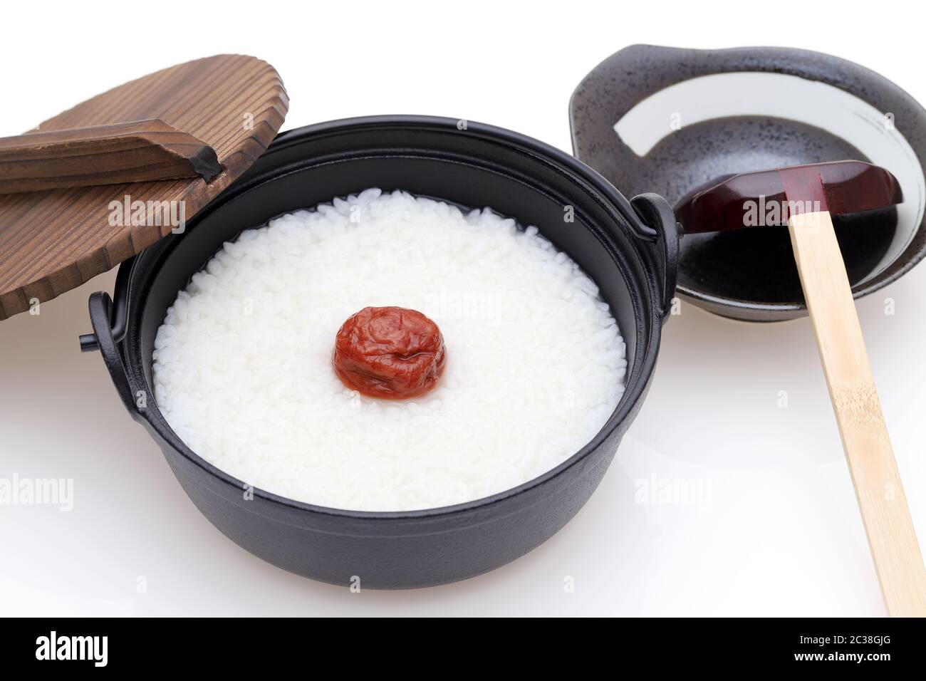 Japanese food, Okayu and Umeboshi in a nabe bowl on white background ...