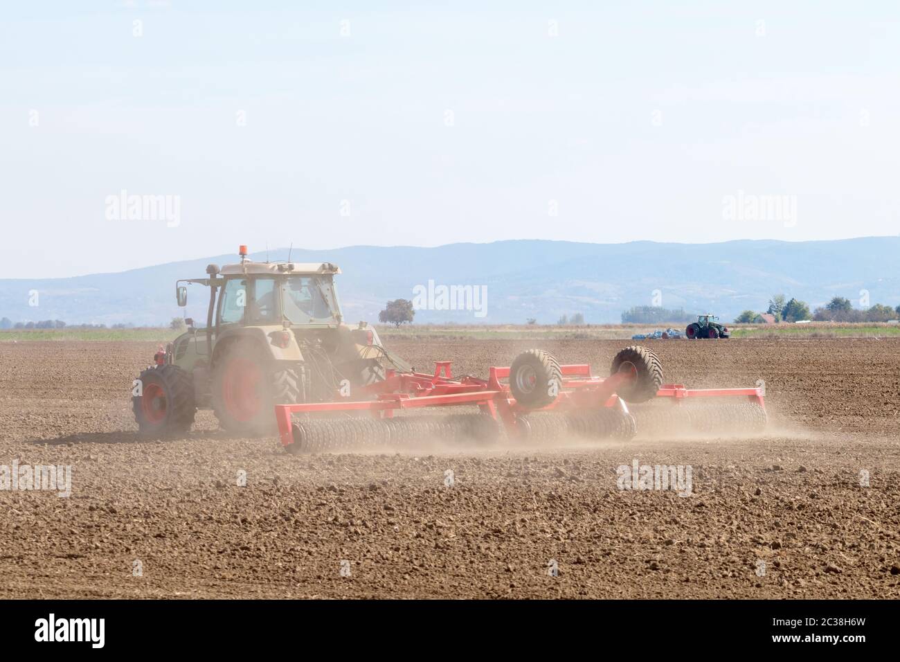 Tractors preparing field, Agriculture tractors Stock Photo - Alamy