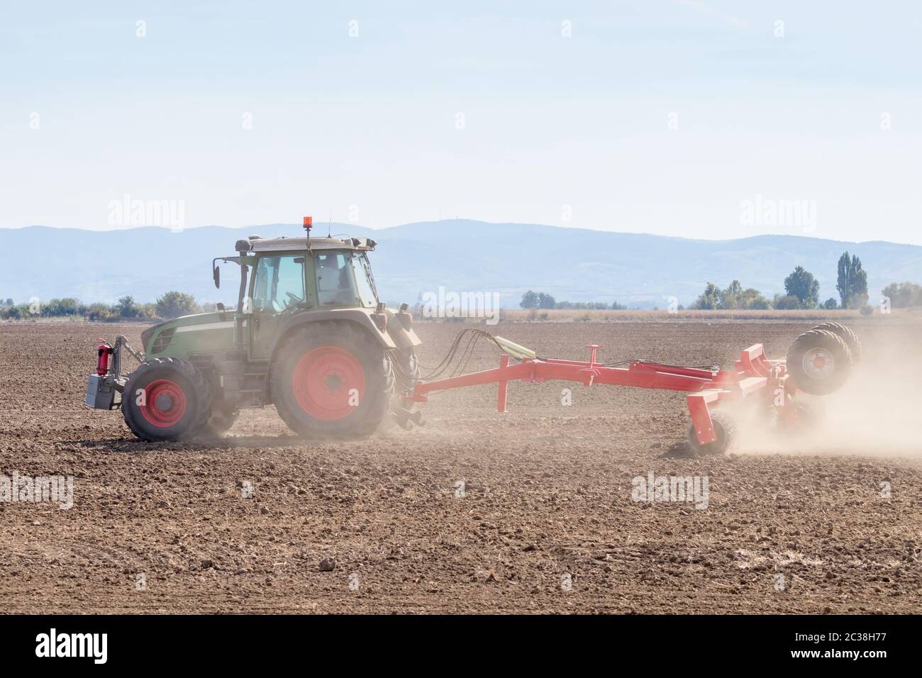Tractor preparing field, Agriculture tractor Stock Photo - Alamy