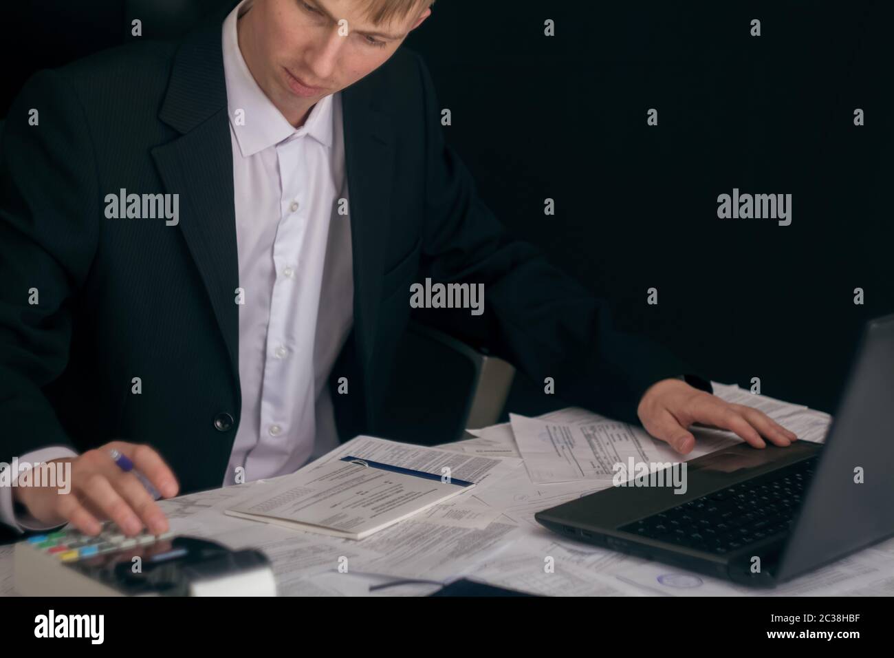 White man working in an office with documents. The Manager makes the ...