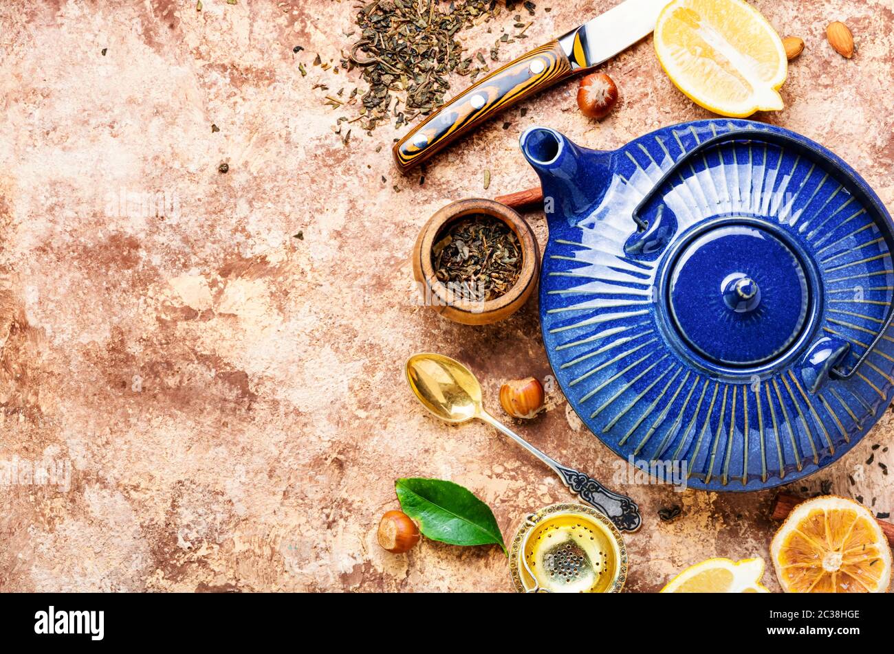 Natural ingredients for tea.Porcelain blue teapot.Useful tea with lemon ...