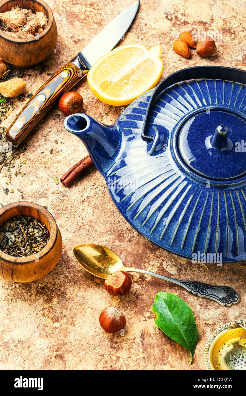 Natural ingredients for tea.Porcelain blue teapot.Useful tea with lemon ...