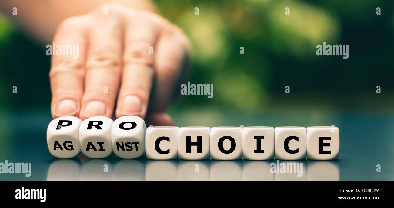 Hand turns dice and changes the expression "against choice" to "pro ...