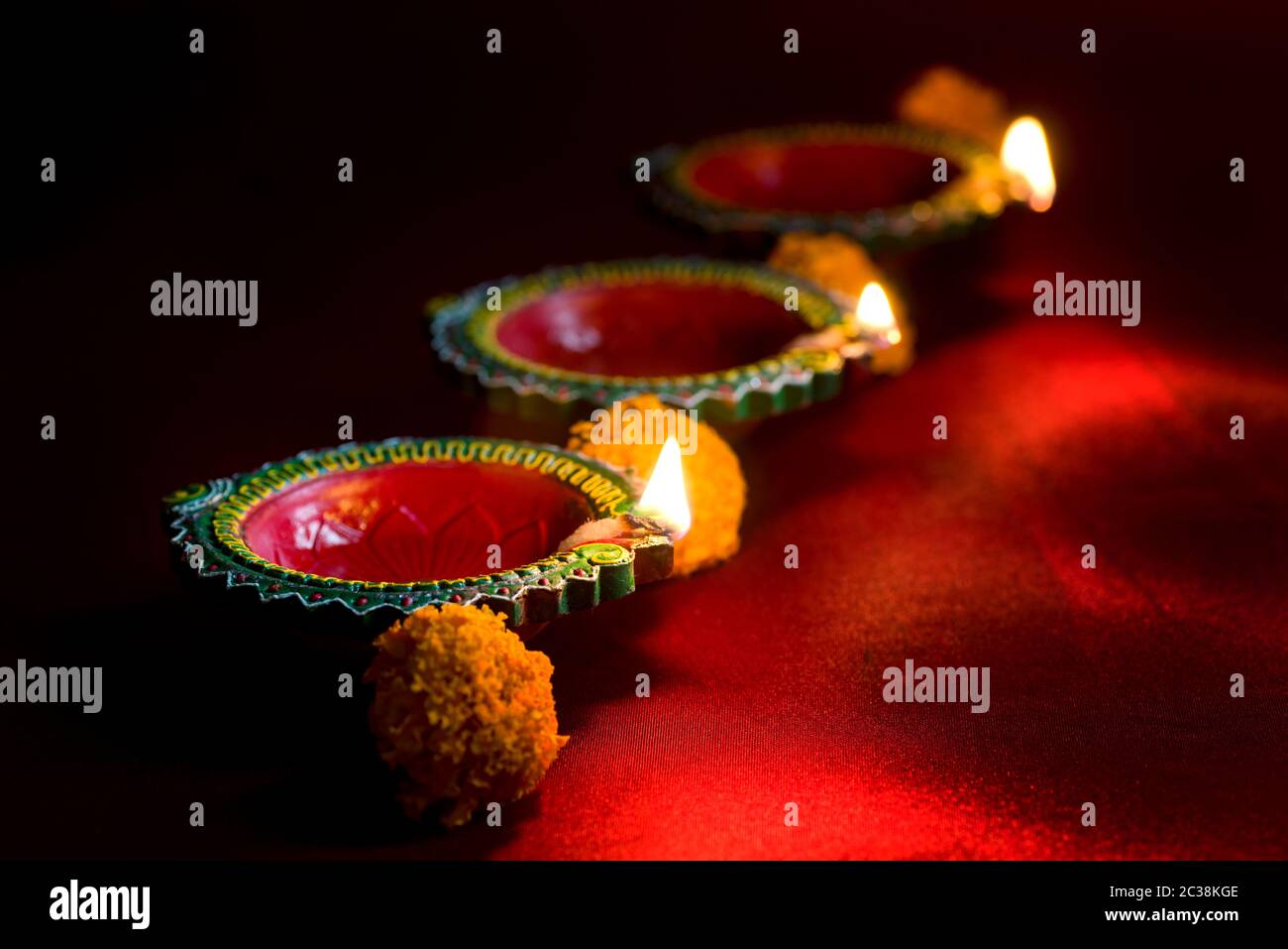 Happy Diwali - Clay Diya lamps lit during Diwali celebration. Greetings ...