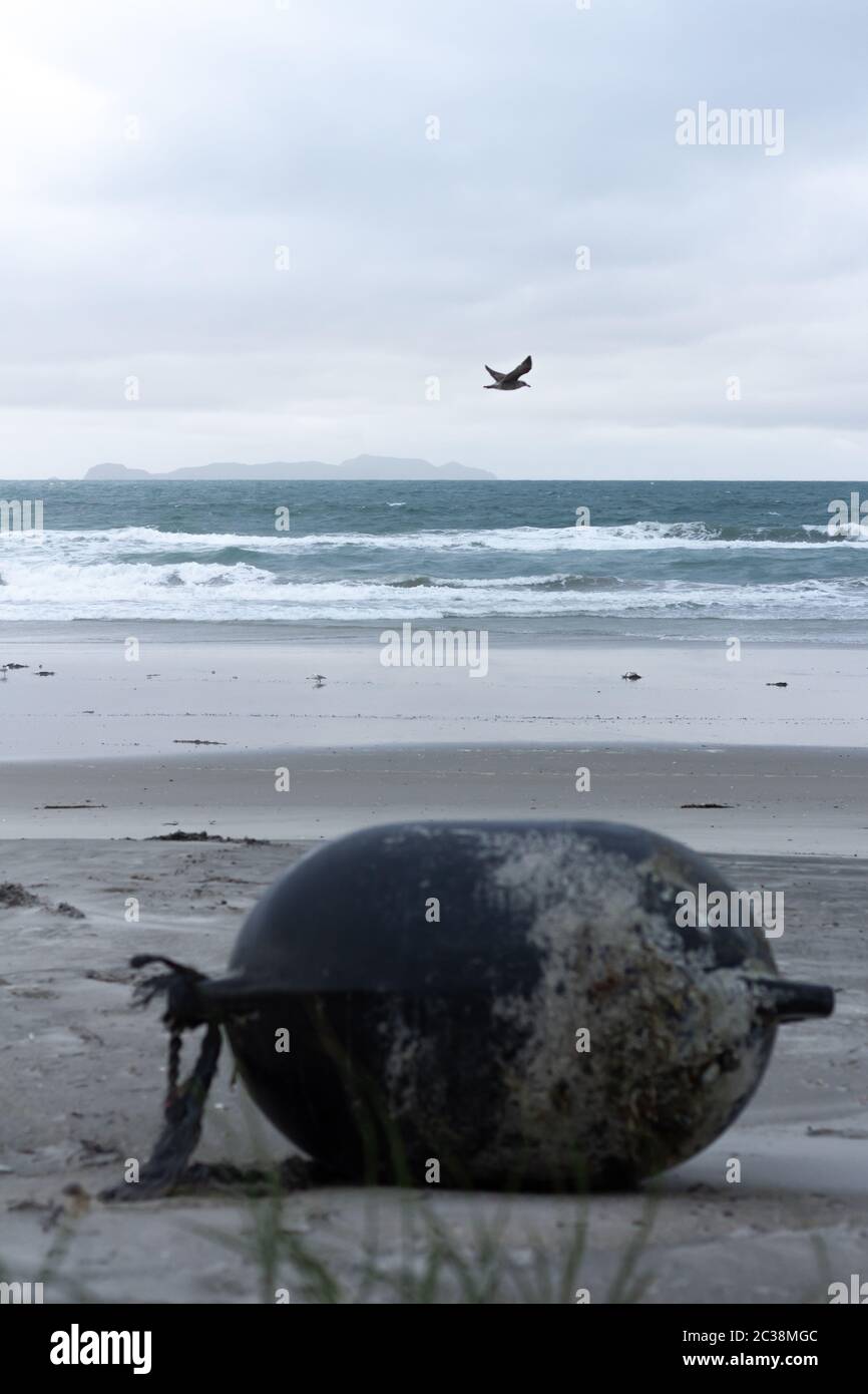 A large fishing buoy washed up on a remote beach Stock Photo - Alamy