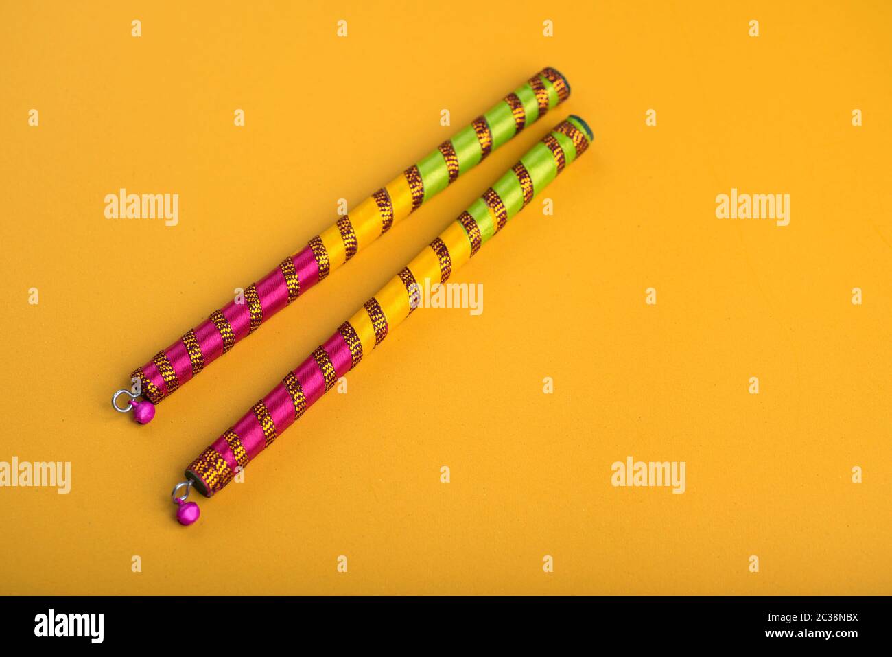 Dandiya sticks on a yellow background. Raas Garba or Dandiya Raas is ...