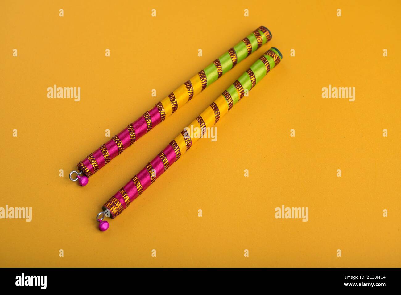 Dandiya sticks on a yellow background. Raas Garba or Dandiya Raas is ...