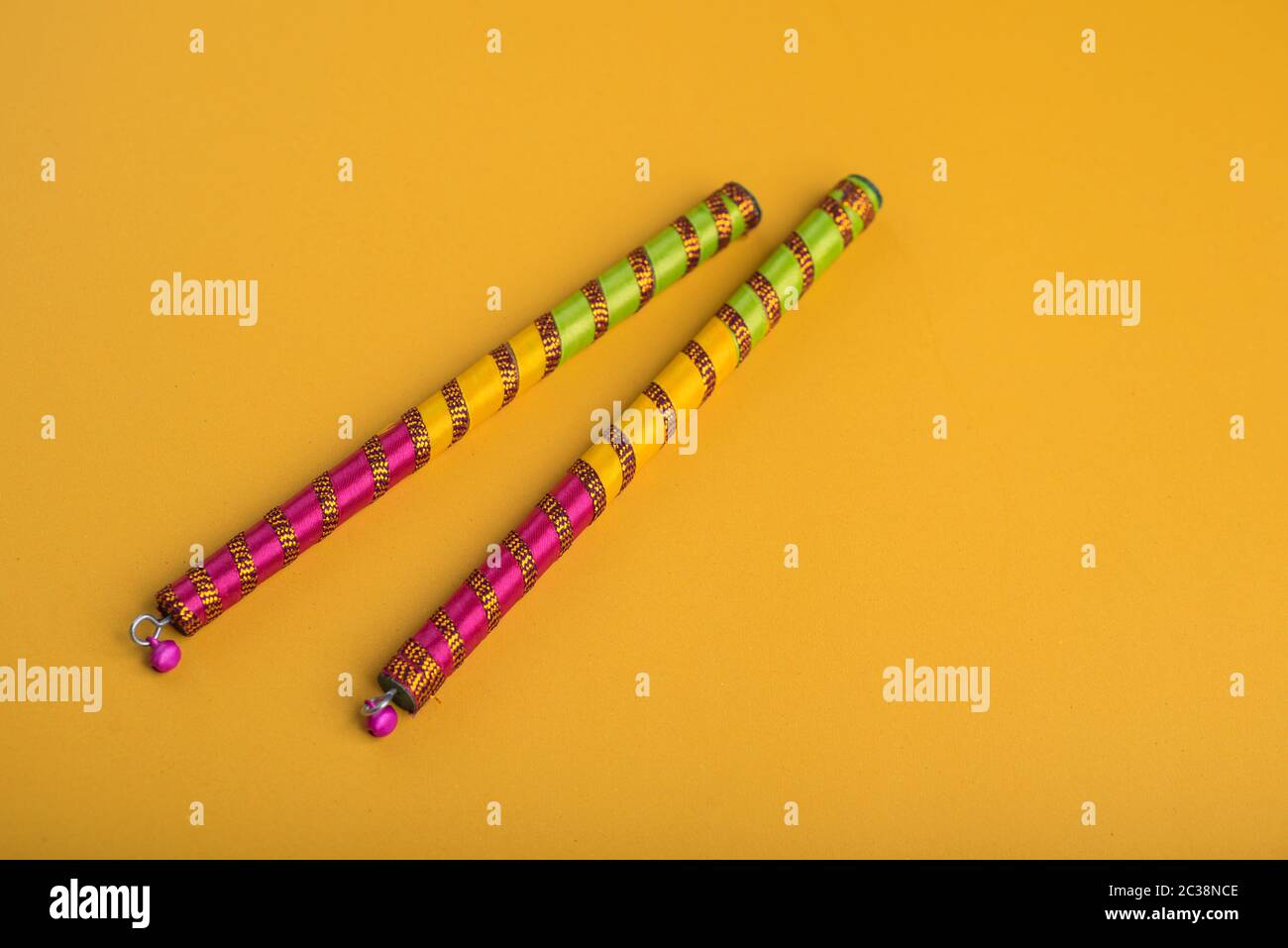 Dandiya sticks on a yellow background. Raas Garba or Dandiya Raas is ...